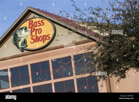A Logo Sign Outside Of A Bass Pro Shops Retail Store In Mesa Arizona