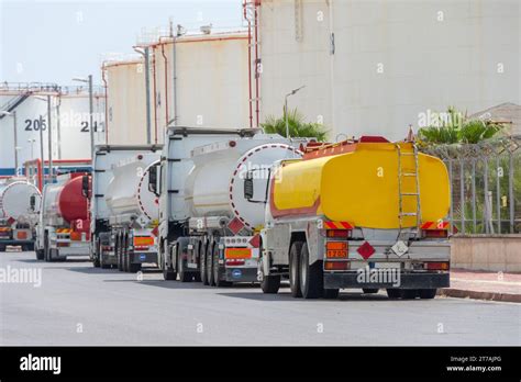 Parking Row Jam Of Trucks With Fuel Tanks In Front Of A Warehouse And Storage Of Huge Tanks Of