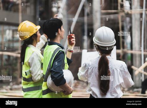 Engineering And Construction Managers Discussing Project Blue Print On