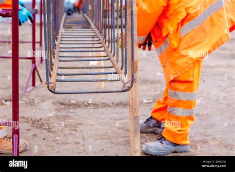 Builders Hands Fixing Steel Reinforcement Bars At Construction Site Steel Fixer Assembling