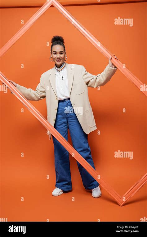 Cheerful African American Fashion Model In Beige Blazer And Blue Pants