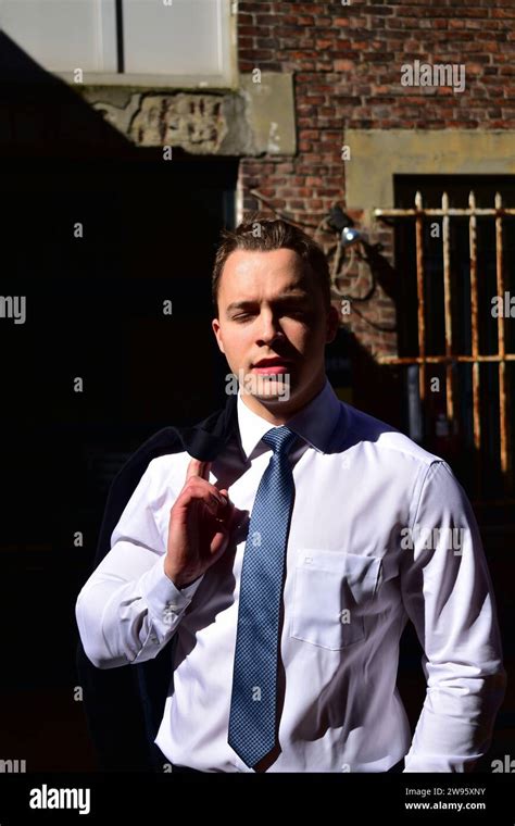 Young Muscular White Man Carrying His Black Suit Jacket Over His