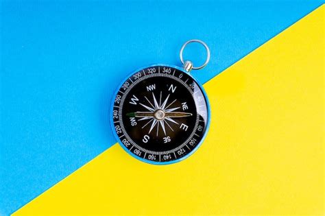 Premium Photo Close Up Of Navigational Compass Over Colored Background