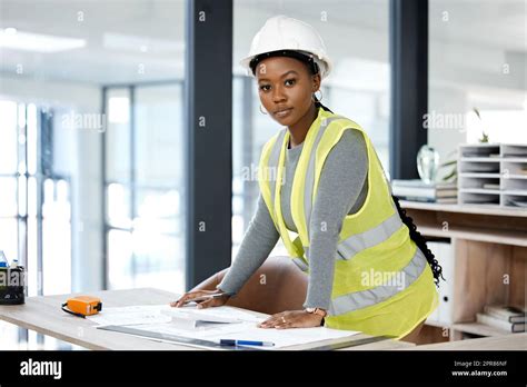 Creating The World You Live In A Female Engineer Drawing Up Blueprints