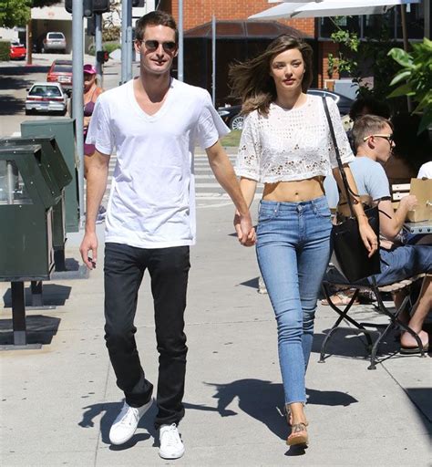 A Man And Woman Walking Down The Street