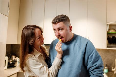 Premium Photo Sheerful Attractive Woman Feeding Her Handsome Husband