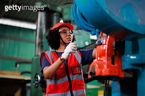 Woman Worker Wearing Safety Goggles Control Lathe Machine To Drill Components Metal Lathe