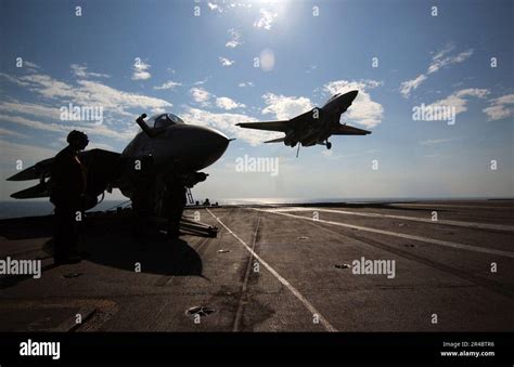 Us Navy An F 14d Tomcat Prepares To Make An Arrested Landing On The Flight Deck Aboard The