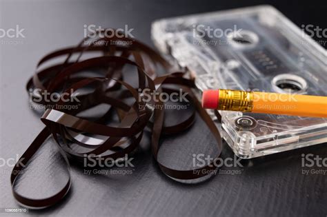 Audio Cassette And Pencil On A Black Table Old Magnetic Data Carrier