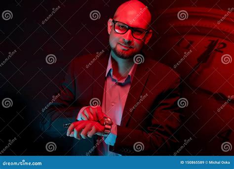Attractive Bald Man With Beard With Glasses On Neon Light Background