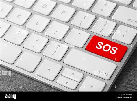 Red Button With Word Sos On Computer Keyboard Closeup Rescue Concept