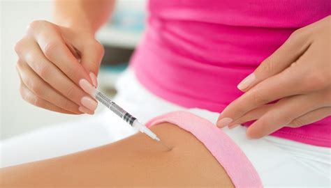 Closeup Of A Young Woman Selfadministering An Injection Into Her Thigh Using A Syringe Premium