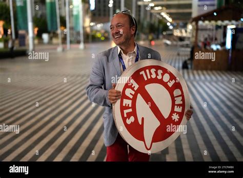 A Man Holds A Sign That Reads End Fossil Fuels At The Cop28 U N