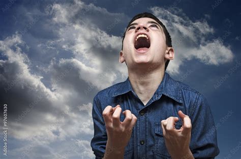 Boy Screaming Angry Caucasian Teenager Screaming Wildly On A Cloudy Sky