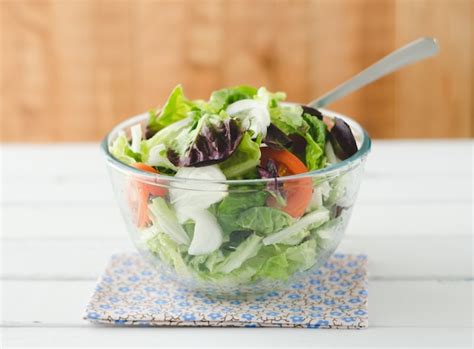 Premium Photo Salad In Glass Bowl On White Wooden