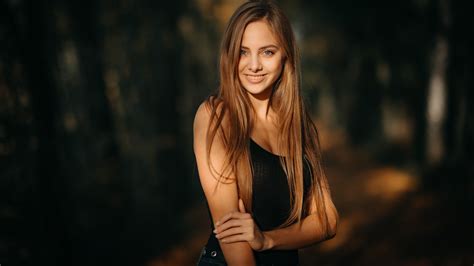 Smiling Women Girl Model Is Standing In Dark Background Wearing Black