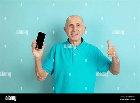 Showing Blank Phones Screen Caucasian Senior Mans Portrait On Blue