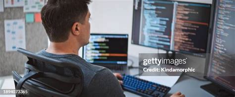 american male software engineer developer use laptop computer at home