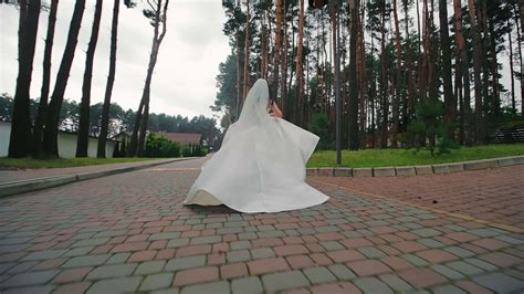 The Bride Is Running In The Park In A White Dress An Unfortunate
