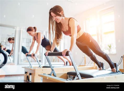 Two Young Females Doing Extended Plank Static Strengthening Core