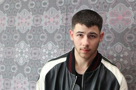 A Young Man Wearing A Black And White Jacket