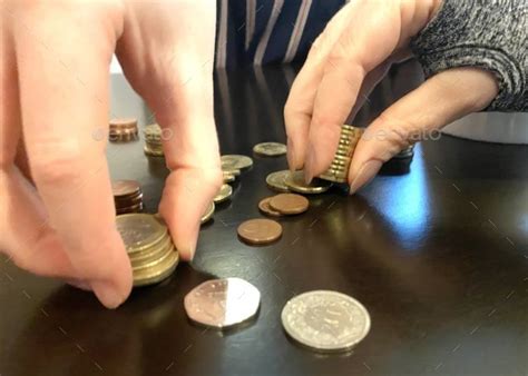 Counting Coins Two Women Count Money Together On A Table Stock Photo By Spencerpa