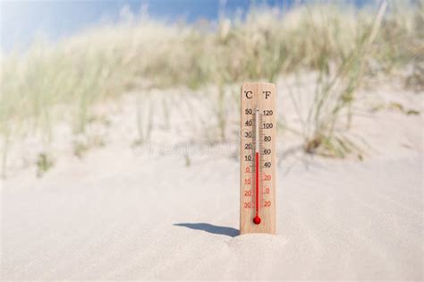 Wooden Celsius And Fahrenheit Scale Thermometer In The Sand Air