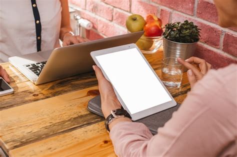 Premium Photo Close Up Girl Holding Tablet While Working In Office