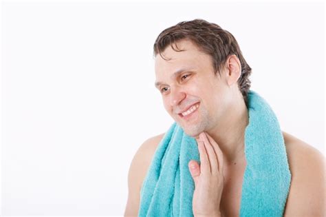 Premium Photo A Man Puts Aftershave On His Face The Guy Strokes His