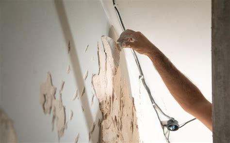 Premium Photo Man Is Applying Putty On A Wall Renovating House