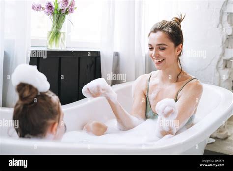 Young Mother Woman And Little Tween Girl Daughter Having Fun In Bath
