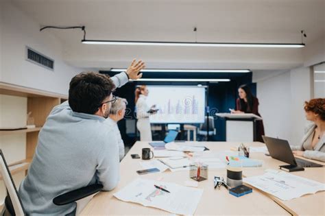 Colleagues Discussing Statistics During A Business Presentation Stock Image Image Of