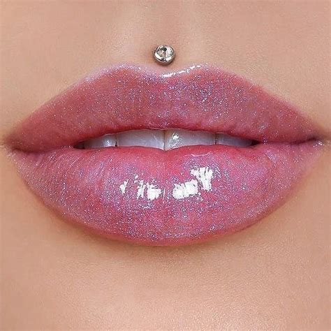 A Womans Lips With Pink Glitter On Them And A Nose Pin In The Middle
