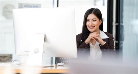 Premium Photo Smiling Woman Sitting At Her Desk In Office Happy