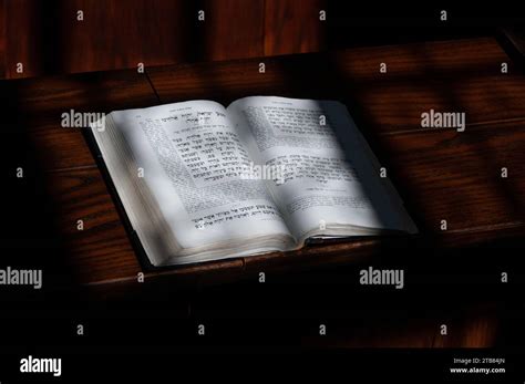 An Open Jewish Prayer Book Or Siddur Lies On A Prayer Stand In A