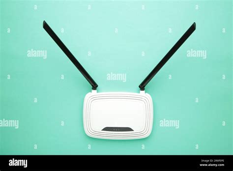 White Wi Fi Router With Black Antennas On Mint Background With Copy Space Minimalism Top View