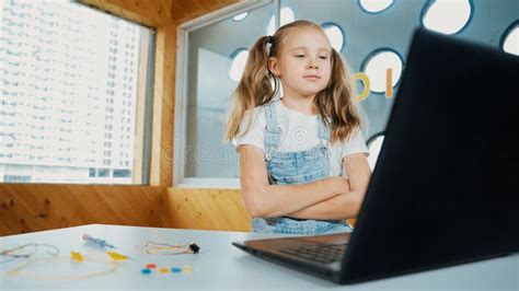 Caucasian Girl Using Laptop Programing Software While Crossing Arms