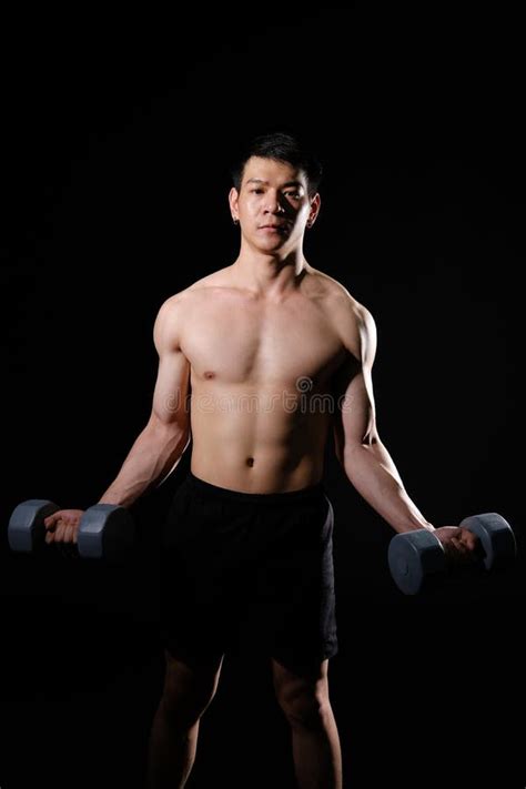 Athletic Muscular Bodybuilder Man With Naked Torso Six Pack Abs Working Out With Dumbbell