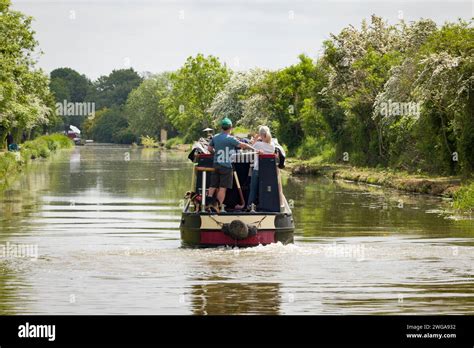 MILTON KEYNES UK May 25 2023 Man And Woman Steer A Narrowboat On