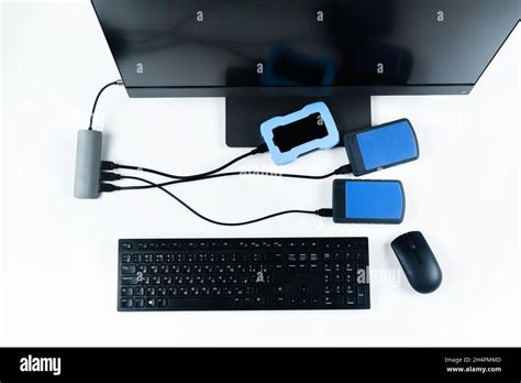 Multiple External Hard Drives Connected To A Monoblock On A White