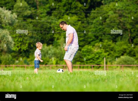Father And Son Playing Football Stock Photo Alamy