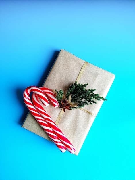 Premium Photo T Wrapped In Craft Paper Candy Canes And Juniper