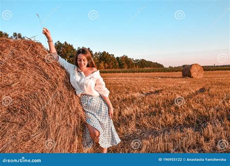 Portrait Of Young Sexy Woman On The Haystack In Morning Sunlight