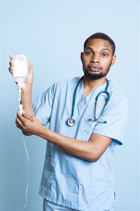 Hospital Staff Holding Iv Bag Preparing To Administer Fluids For