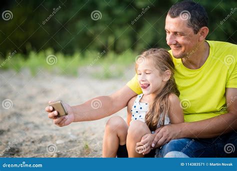 Smiling Father Taking Selfie With Young Daughter Outdoors Stock Image