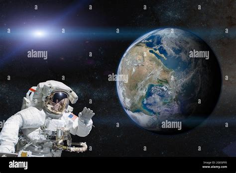 Astronaut In Outer Space On Background Of The Earth Elements Of This