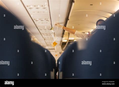 Flight Attendant Showing How To Use Oxygen Mask Before Taking Off Stock