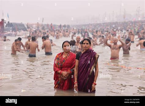 Pilgrims Bathing In The Ganges At The Triveni Sangam On The Auspicious