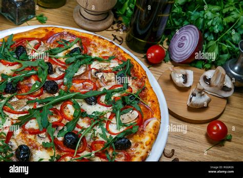 Veggie Pizza With Mushrooms Cherry Tomatoes Black Olives And Herbs
