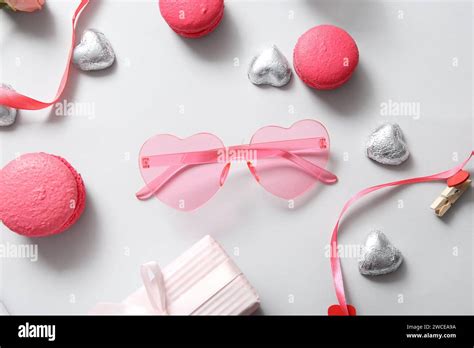 Pink Heart Shaped Sunglasses With Sweets And Decor On White Background